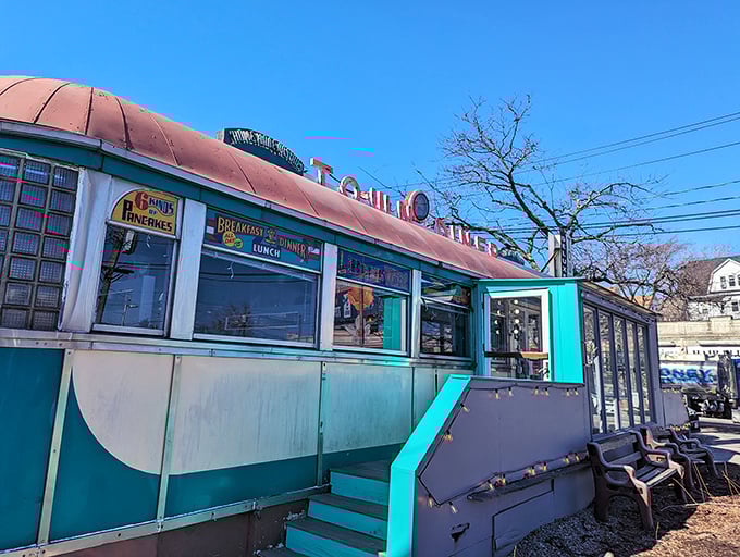 The iconic curved roof and turquoise trim of Deluxe Town Diner stands as a beacon of breakfast hope on Mt. Auburn Street.