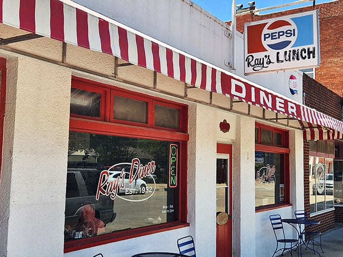 The classic white facade with red-striped awning isn't just inviting&mdash;it's practically a time machine to when breakfast cost less than your morning latte.