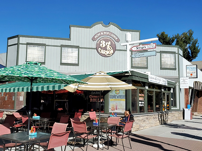 The cheerful exterior of Mom & Pop's Diner promises paradise in pancake form, with its inviting red umbrellas and laid-back Carson City charm.