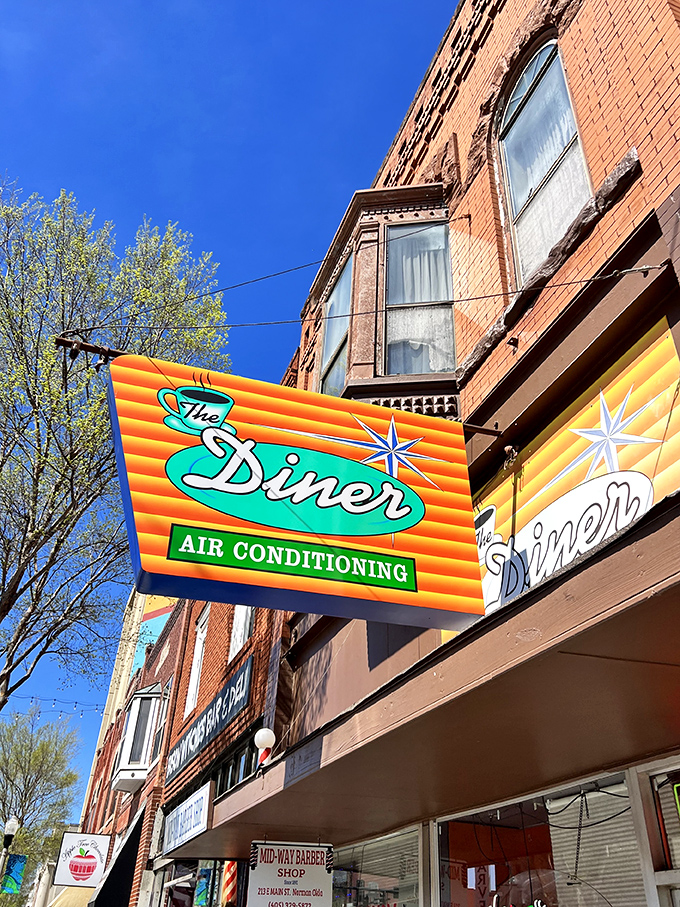 That iconic orange and teal sign doesn't just promise air conditioning&mdash;it's announcing your arrival at breakfast paradise on Main Street.