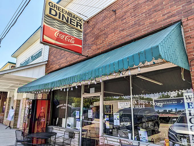 The classic brick exterior with its vintage Coca-Cola sign and green awning isn't trying to be retro-cool&mdash;it's the real deal, standing proudly since 1933.