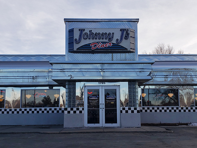 The classic blue-and-white facade of Johnny J's Diner stands as a beacon of comfort food in Casper, Wyoming—checkerboard trim signaling breakfast paradise within.