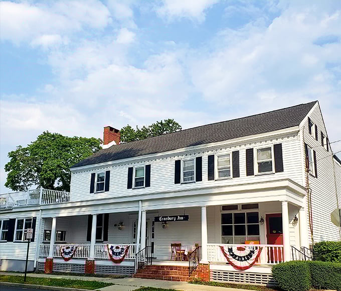 A slice of Americana served with a side of history! The Cranbury Inn stands proud, its white clapboard exterior a beacon for hungry time travelers.