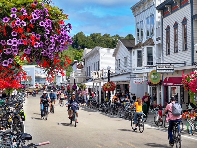 Step back in time on Mackinac Island's Main Street, where horse-drawn carriages and bicycles reign supreme. It's like someone hit pause on the 19th century, but with better ice cream options.