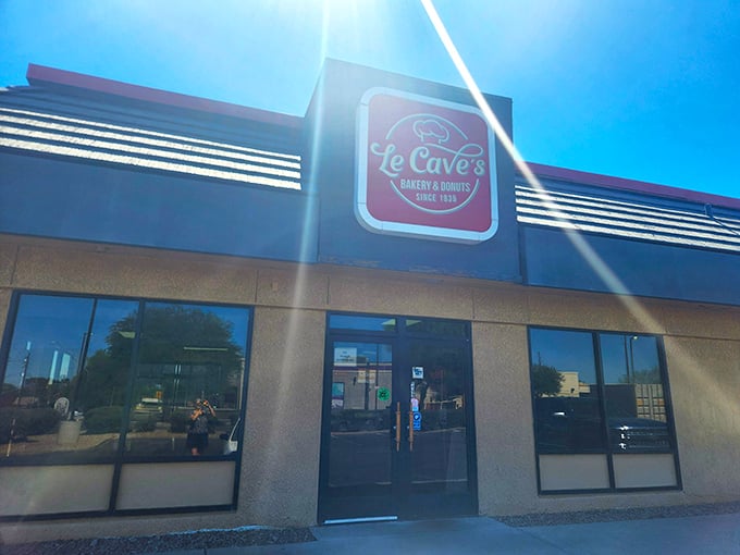 Welcome to donut paradise! Le Cave's iconic red sign beckons like a sugary lighthouse, guiding sweet-toothed sailors to shore since 1935.