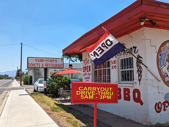Welcome to Yum-Yum's, where the neon "OPEN" sign might as well say "Abandon all diets, ye who enter here!" This unassuming exterior hides a treasure trove of deliciousness.