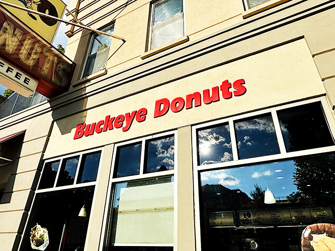 A beacon of sweetness! Buckeye Donuts stands proud, its red lettering a siren call to carb-lovers and night owls alike. Who needs sleep when you've got 24/7 donuts?