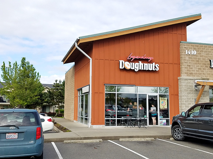 Welcome to donut paradise! Legendary Doughnuts' rustic red exterior promises sweet adventures within, like Willy Wonka's factory for grown-ups.