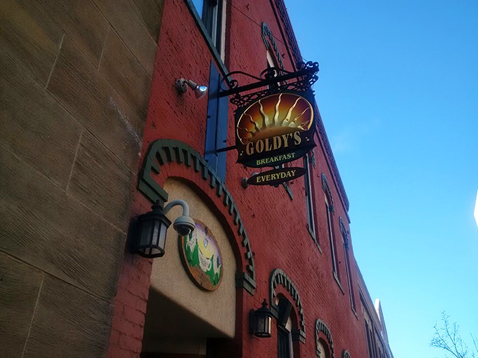 A red-brick beacon of breakfast bliss! Goldy's charming exterior promises morning magic within its cozy confines.