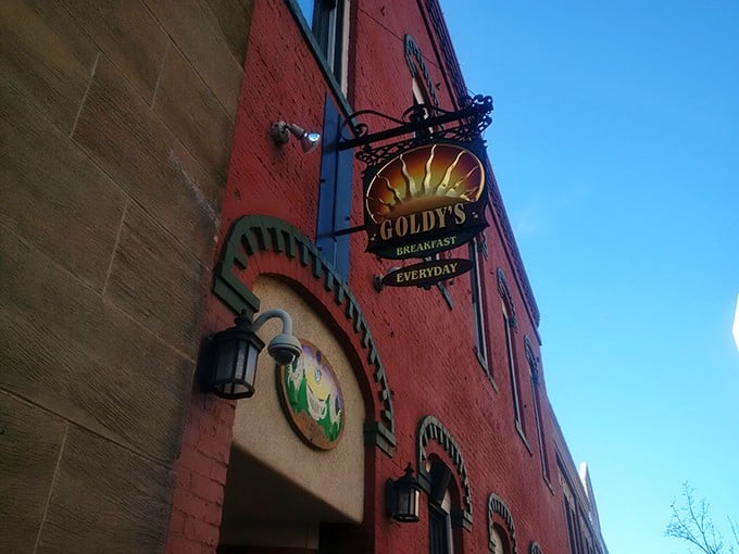 A red-brick beacon of breakfast bliss! Goldy's charming exterior promises morning magic within its cozy confines.