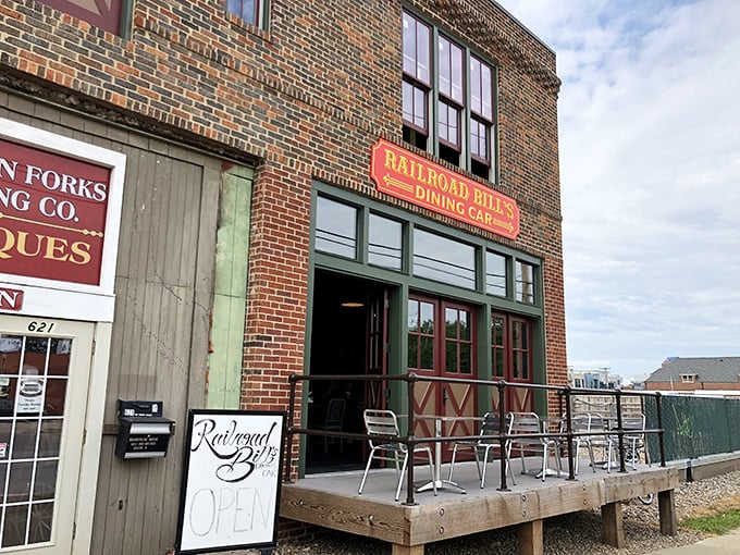 All aboard the flavor express! Railroad Bill's Dining Car beckons with its charming brick facade and inviting wooden deck, promising a journey through culinary delights.