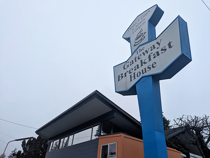 A beacon of breakfast bliss! This blue-and-white sign promises a journey into the land of fluffy pancakes and endless coffee refills.