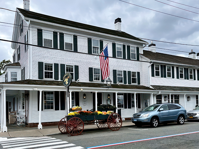 A slice of Americana served with a side of maritime charm. The Griswold Inn's white clapboard exterior whispers tales of centuries past, while the American flag proudly waves hello.