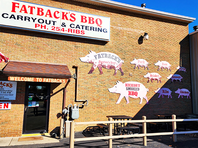 The unassuming brick exterior of Fatback's BBQ hides culinary treasures within. Those pig cutouts aren't just decoration&mdash;they're a roadmap to happiness.