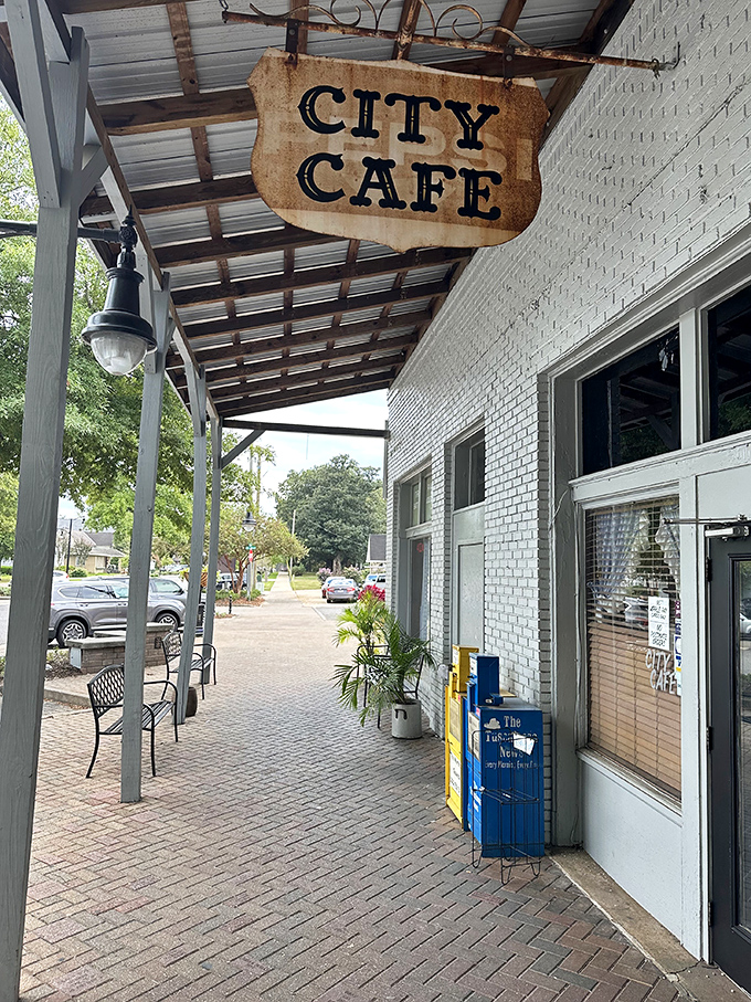 Step into a time machine disguised as a diner! City Cafe's weathered sign promises a journey back to simpler times and hearty meals.