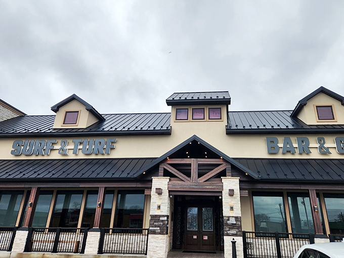 A culinary beacon in Milford! Surf & Turf Bar & Grill's exterior promises a feast for the senses, with its inviting wooden accents and twinkling lights.