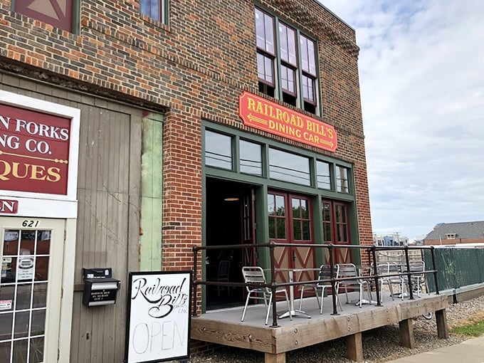 All aboard the flavor express! Railroad Bill's Dining Car beckons with its charming brick facade and inviting wooden deck, promising a journey through time and taste.