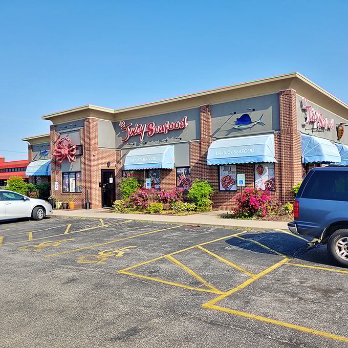 Welcome to seafood paradise! La Juicy Seafood's exterior promises a feast for the senses, with its cheerful blue awnings and grinning crab mascot.