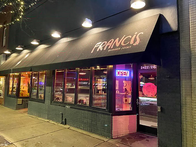 Welcome to burger paradise! Francis Burger Joint's sleek exterior promises a feast for the senses, with its inviting awning and warm glow beckoning hungry patrons.