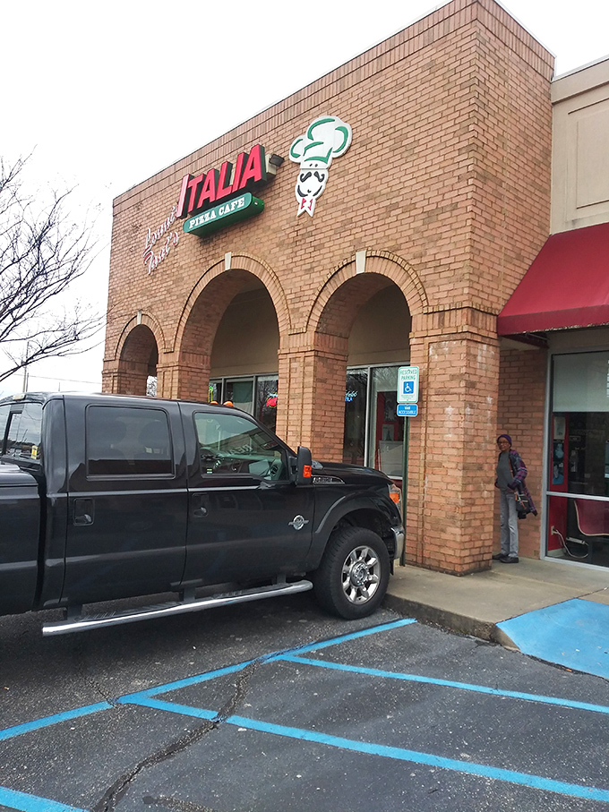 Welcome to pizza paradise! Italia Pizza Cafe's unassuming exterior hides a world of cheesy delights, proving you should never judge a book by its brick-and-mortar cover.