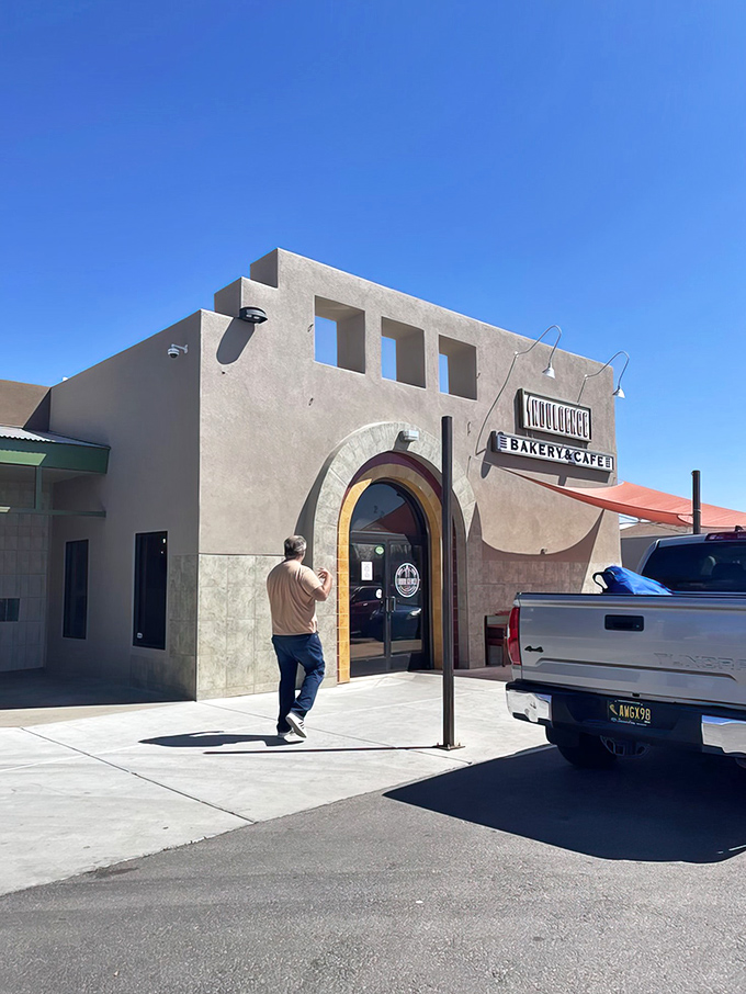 Welcome to flavor town! Indulgence Bakery & Cafe's exterior promises a rainbow of tastes, with its vibrant arch beckoning food lovers like a culinary pot of gold.