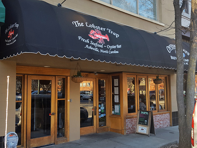 A siren song for seafood lovers! The Lobster Trap's classic black awning and bright red logo beckon you into a world where mountain meets ocean.