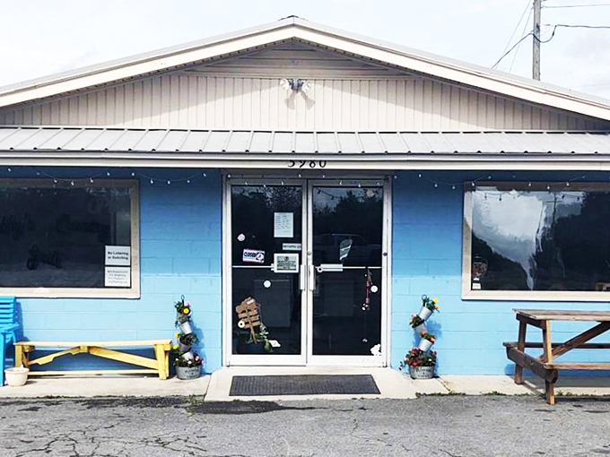 A blue beacon of breakfast bliss! Sweet Bee's Country Grill stands out against the sky, promising comfort food and small-town charm.