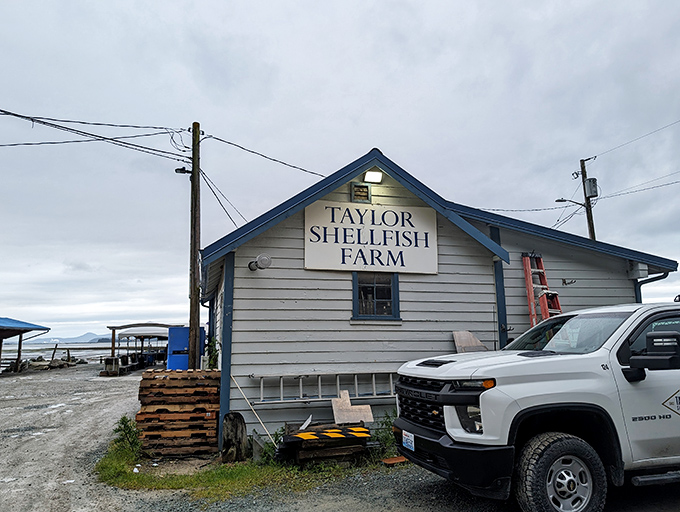 Welcome to seafood paradise! This charming blue-roofed shack might look unassuming, but it's about to rock your taste buds like a tidal wave.