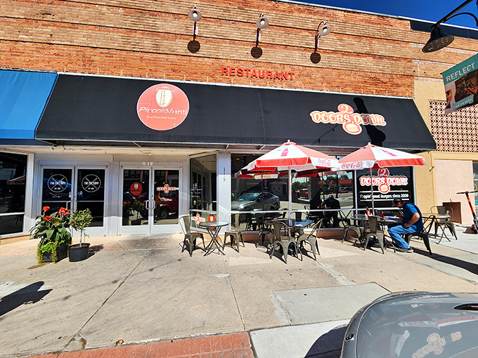 Welcome to burger paradise! 2 Doors Down's inviting storefront promises a feast for the senses, with those red umbrellas practically winking at you to come inside.