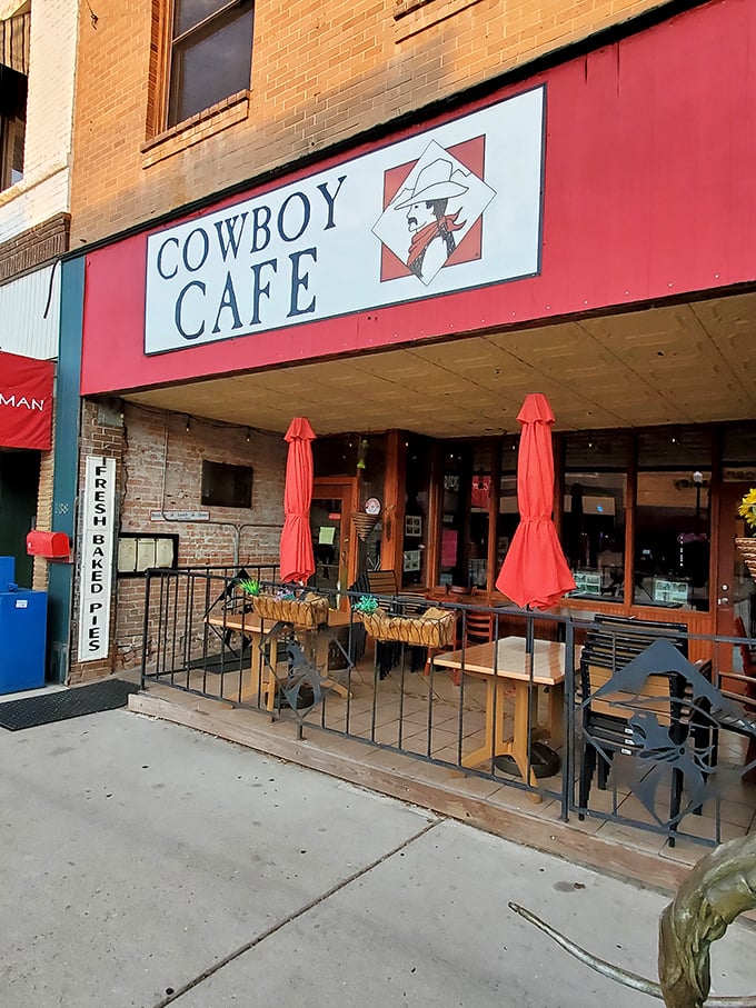 Howdy, partner! The Cowboy Cafe's vibrant red awning is like a beacon for hungry travelers, promising Western hospitality and hearty grub.