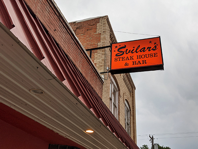 A red-brick beacon of culinary delight! Svilar's Steak House & Bar stands proud, its neon sign a siren call to hungry travelers and locals alike.