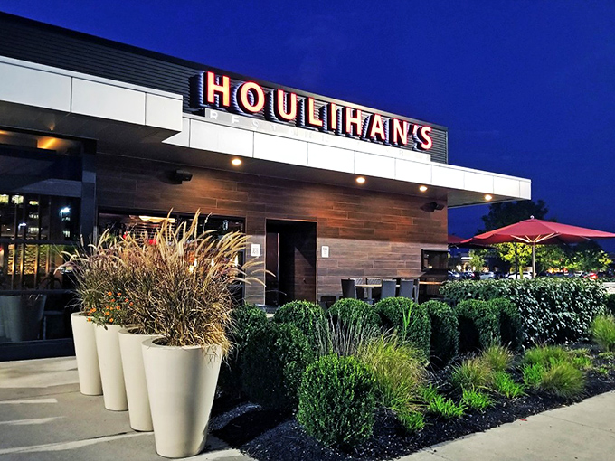 The beacon of comfort food gleams at dusk, with Houlihan's warm glow inviting hungry travelers like moths to a buttery, potato-scented flame.