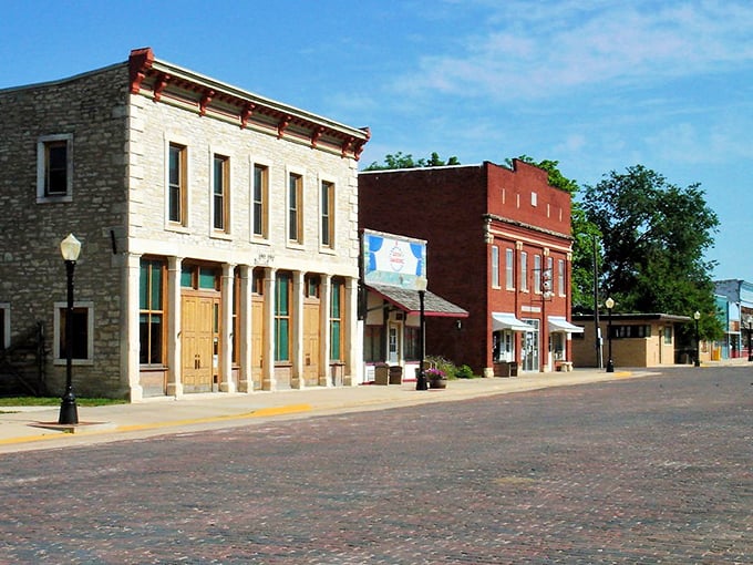 The Chase County Courthouse stands like a Victorian sentinel at the end of Broadway Street, its red mansard roof and limestone walls creating an unforgettable silhouette against the Kansas sky.