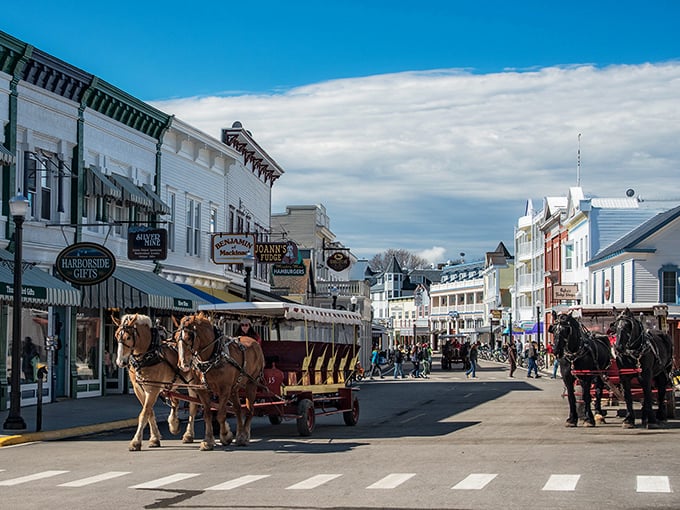 Step back in time on Mackinac Island's Main Street, where horse-drawn carriages and bicycles reign supreme. It's like someone hit pause on the 19th century, but with better ice cream options.