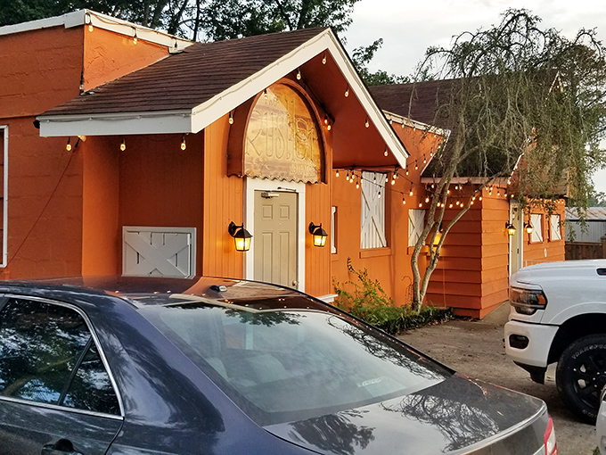 Welcome to The Rustler, where the exterior is as warm and inviting as the prime rib inside. This cozy orange oasis is like a beacon for beef lovers, beckoning you with its twinkling lights and promise of culinary delights.