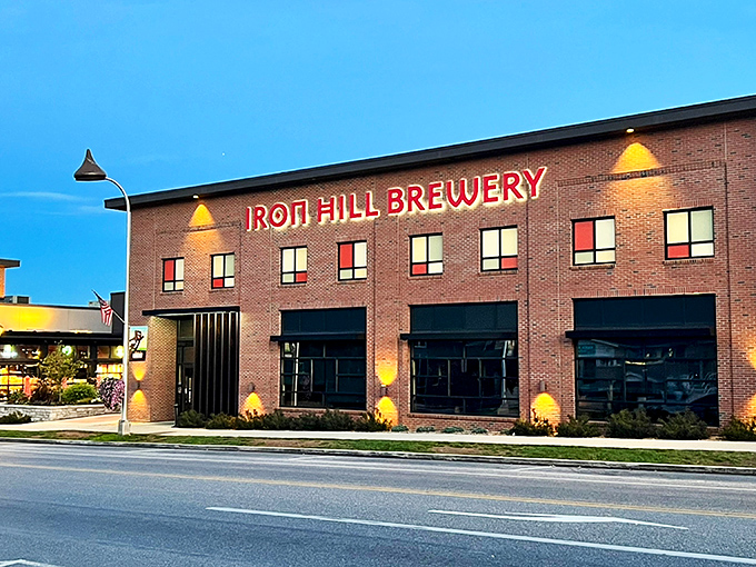 Iron Hill's brick facade glows at twilight, a beacon of craft beer and culinary promise in the heart of Hershey. Like finding an oasis after a chocolate factory tour.