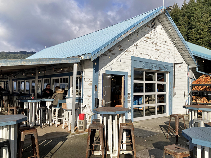 Welcome to seafood paradise! This charming blue-roofed shack might look unassuming, but it's about to rock your taste buds like a tidal wave.
