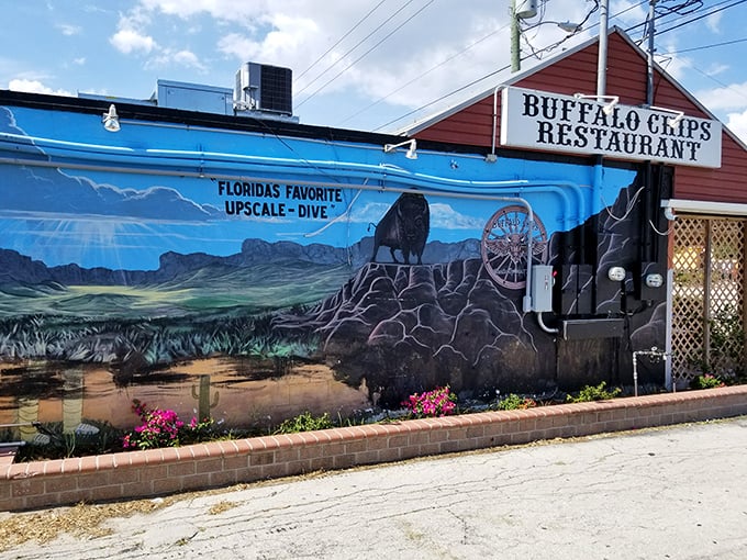 The unmistakable red exterior of Buffalo Chips, where that magnificent buffalo mural isn't just decoration&mdash;it's a promise of what awaits your taste buds inside.