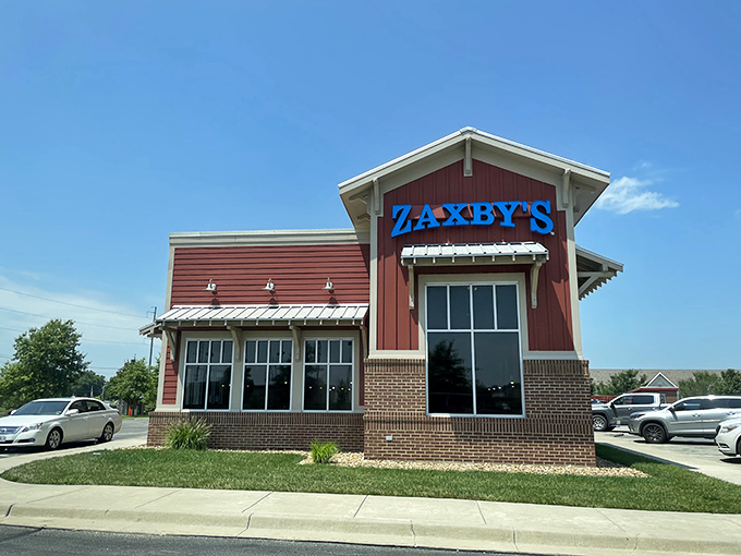Welcome to flavor town! Zaxby's bold blue sign beckons like a neon lighthouse, guiding hungry souls to a chicken paradise.