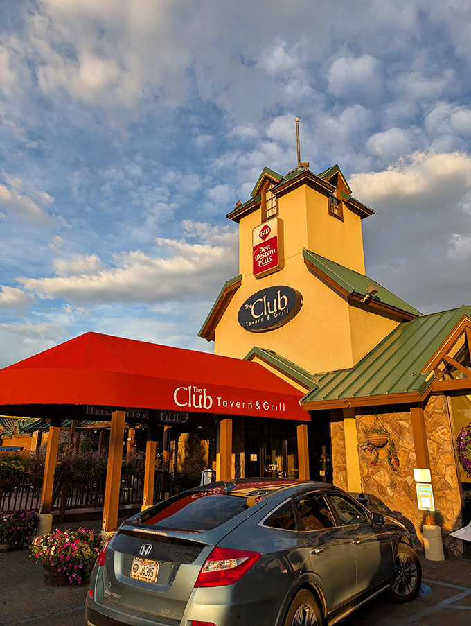 A beacon of deliciousness! The Club Tavern and Grill stands tall, its yellow exterior and red awning beckoning hungry travelers like a culinary lighthouse in the heart of Bozeman.