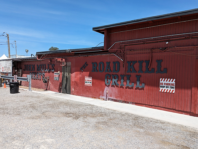The unassuming red exterior of Road Kill Grill stands like a barbecue beacon in the desert, promising smoky treasures within its humble walls.