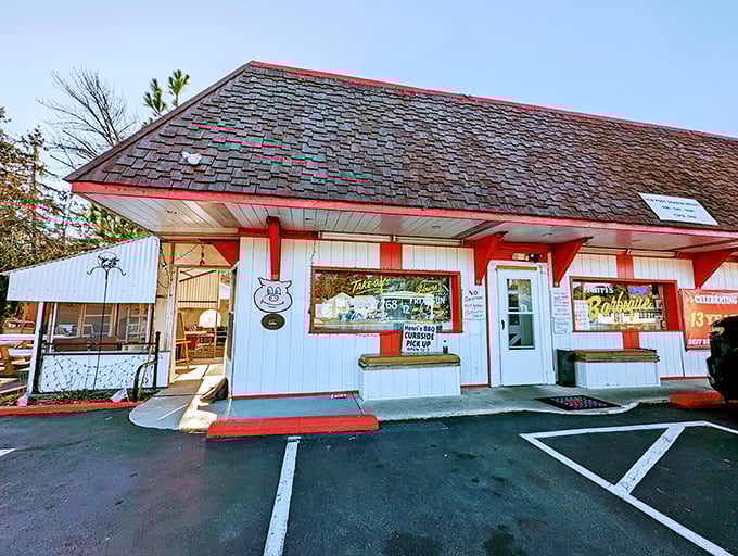 Welcome to barbecue heaven! Henri's Hotts Barbecue stands proud, its red-trimmed exterior promising smoky delights that'll make your taste buds do a happy dance.