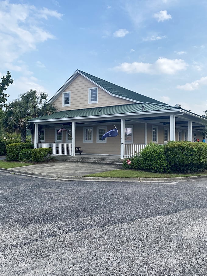 Home sweet smokehouse! This charming cottage-style exterior with its inviting porch says "grandma's cooking" before you even walk through the door.