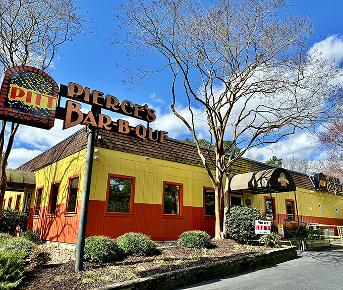 Welcome to barbecue paradise! Pierce's Pitt Bar-B-Que's vibrant yellow exterior is like a beacon for hungry souls seeking smoky salvation.