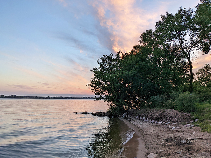 Big Stone Lake's serene beauty beckons. A wooden dock invites adventure, promising fishing tales and sunset views at Minnesota's hidden gem.