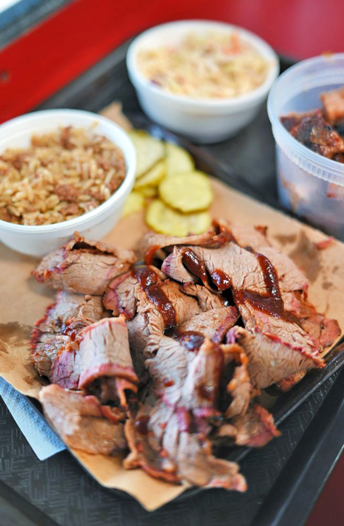 Sliced brisket with that telltale pink smoke ring&mdash;nature's way of saying "this was done right" in a language everyone understands.