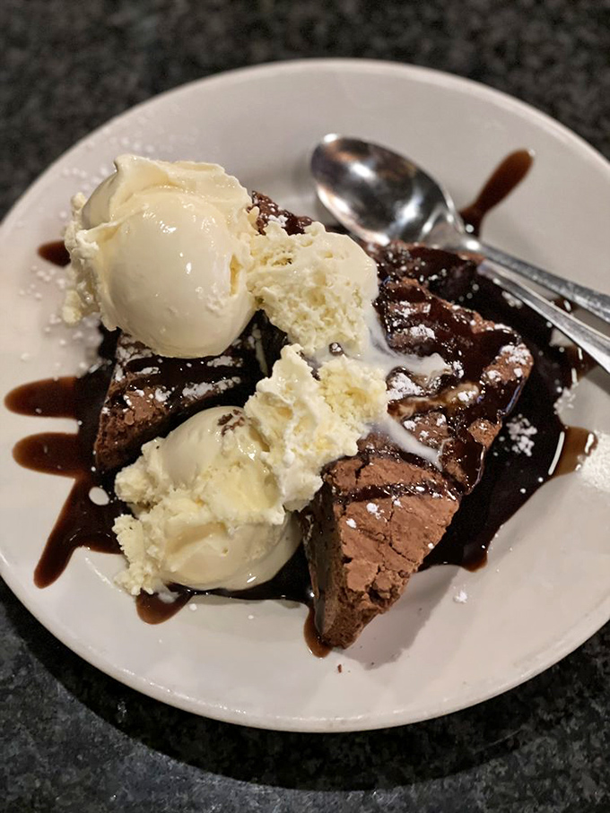 The chocolate finale that justifies saving room for dessert. Those melting ice cream rivers aren't just toppings&mdash;they're the sweet reward for good dining decisions.