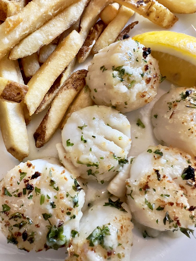 Scallops that look like they're doing a delicious dance on your plate. Paired with those fries, it's a surf and turf tango.