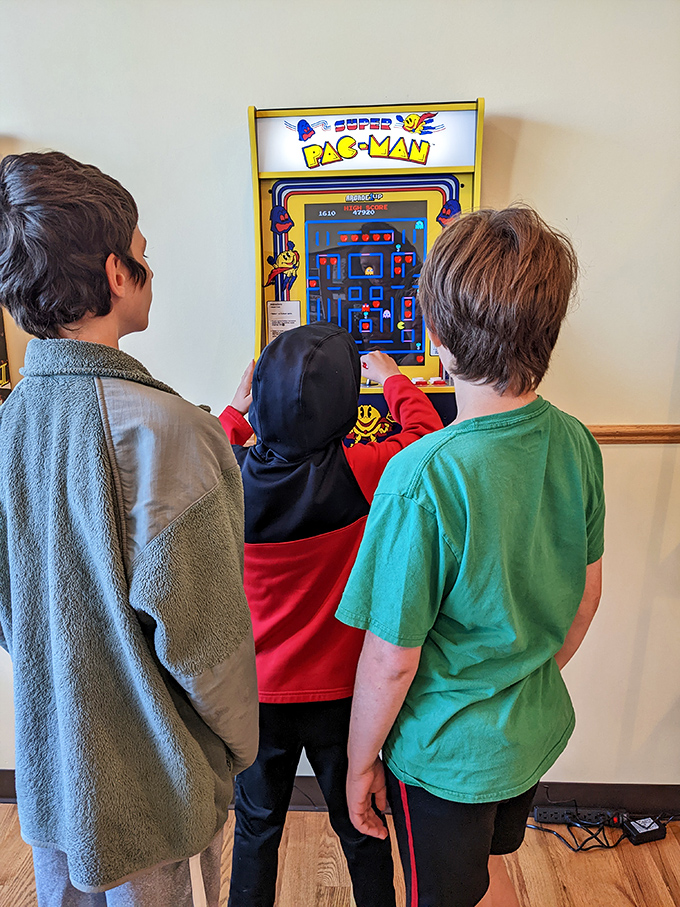 The Super Pac-Man arcade machine&mdash;where kids build hand-eye coordination while parents finish their coffee in what can only be described as a win-win situation.