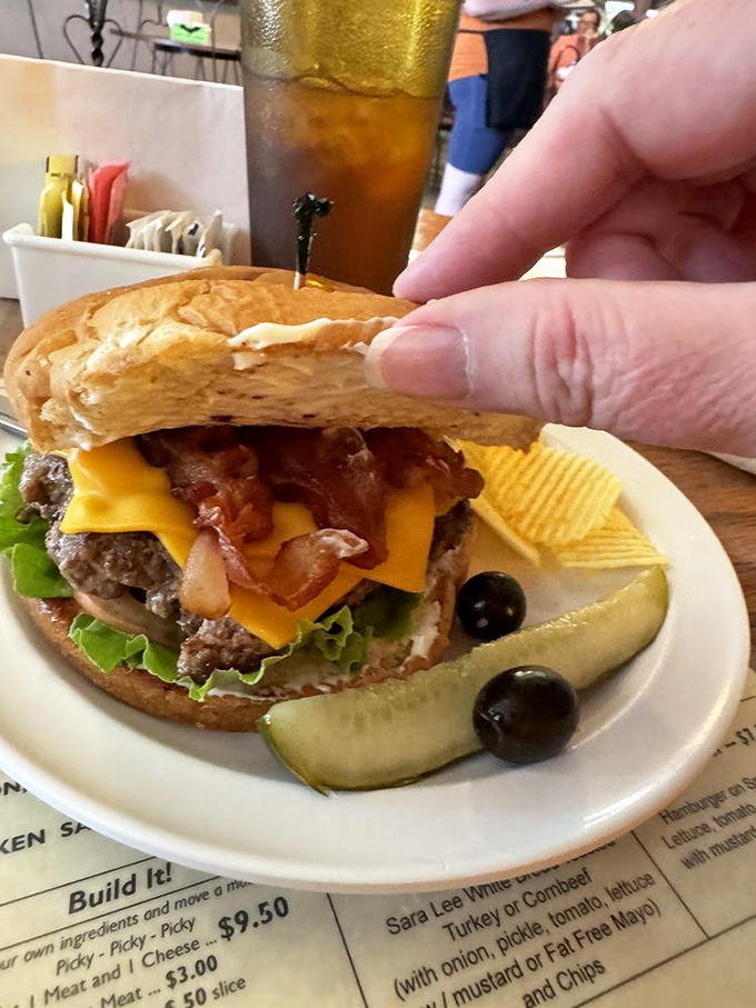 A burger that reminds you why Americans invented the napkin. That melted cheese is performing gravity-defying acts worthy of a Vegas show.